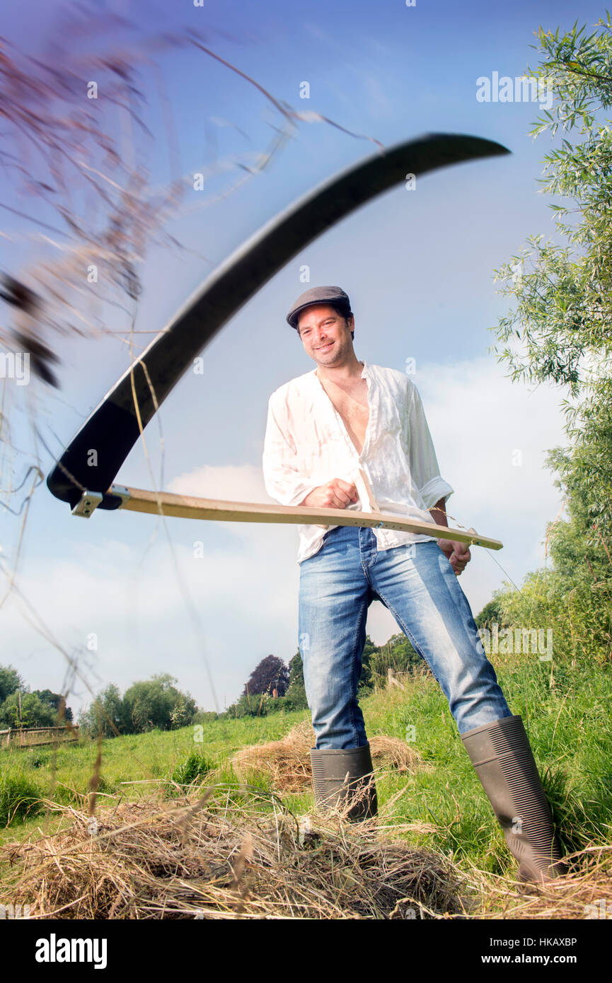 A man scything his field UK Stock Photo - Alamy