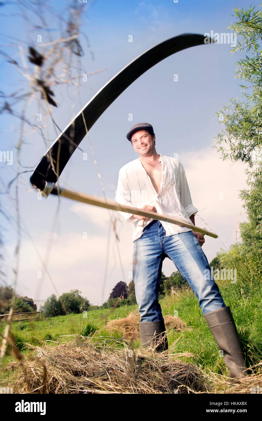 A man scything his field UK Stock Photo - Alamy