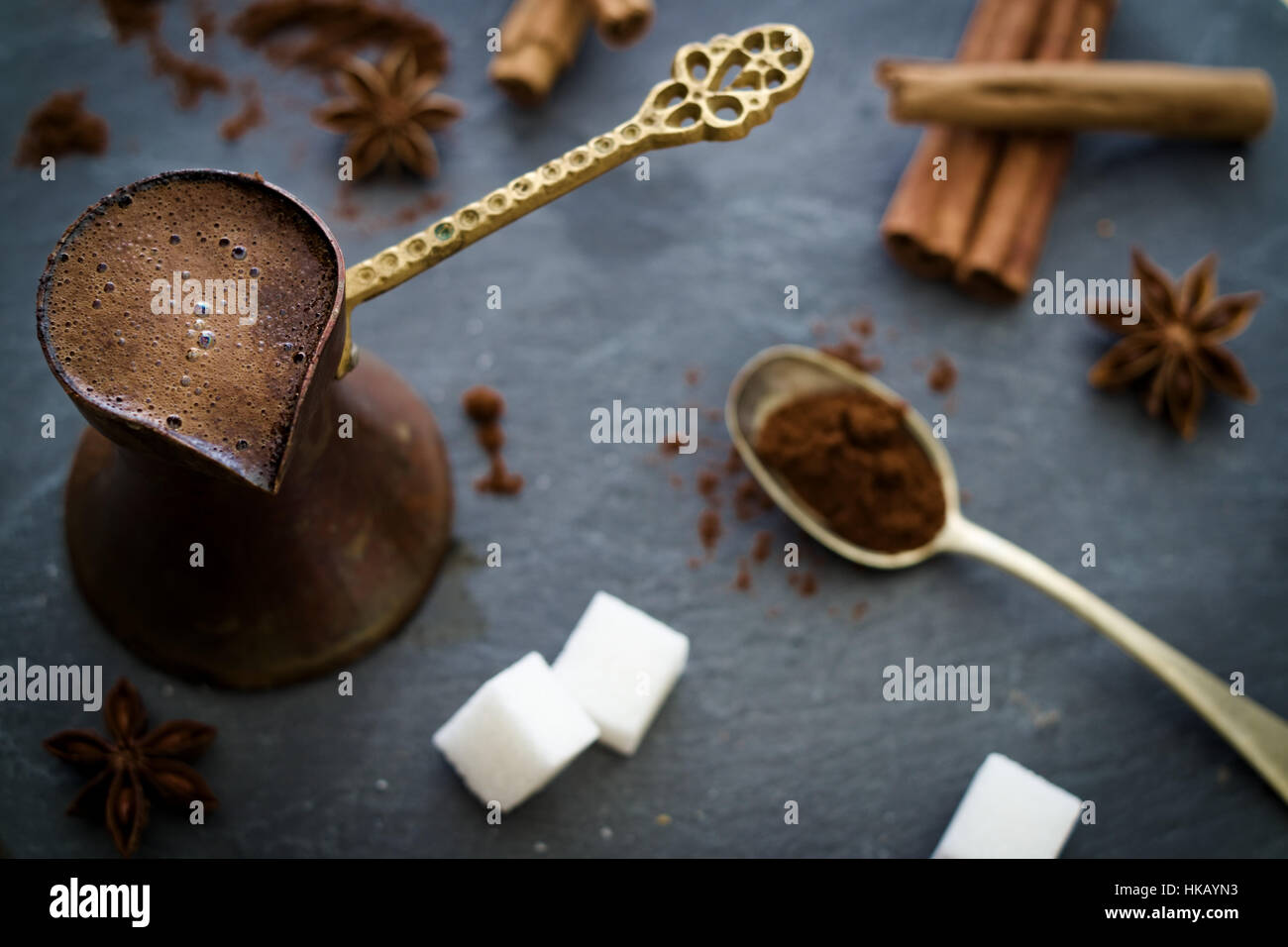 Black turkish coffee with sugar cubes, cinnamon sticks and anise star ...