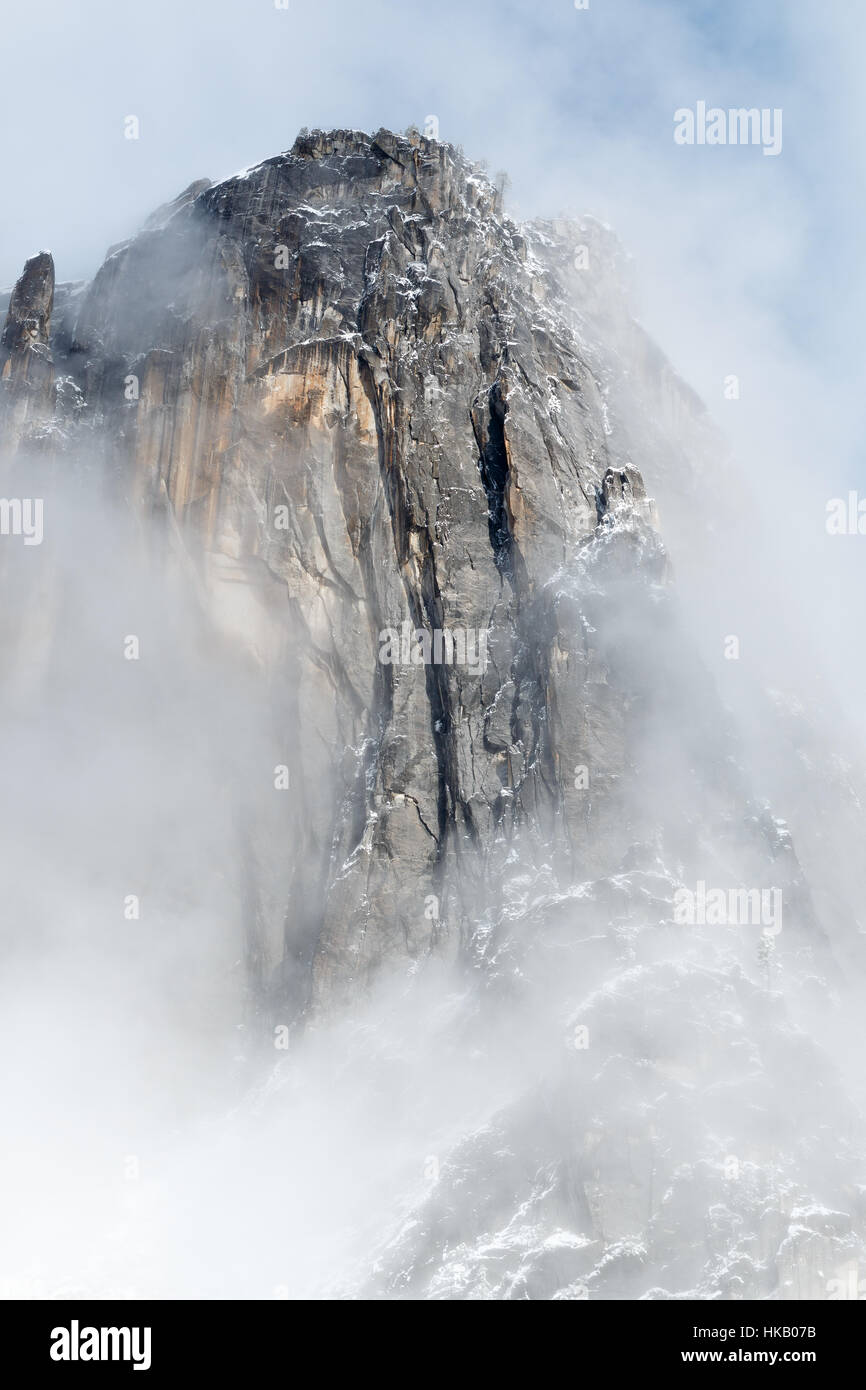 Granite spire surrounded by clouds, California, Yosemite National Park ...