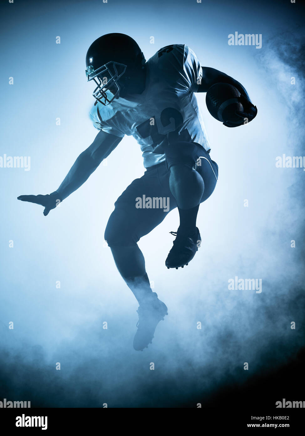 one american football player portrait in silhouette shadow on white ...