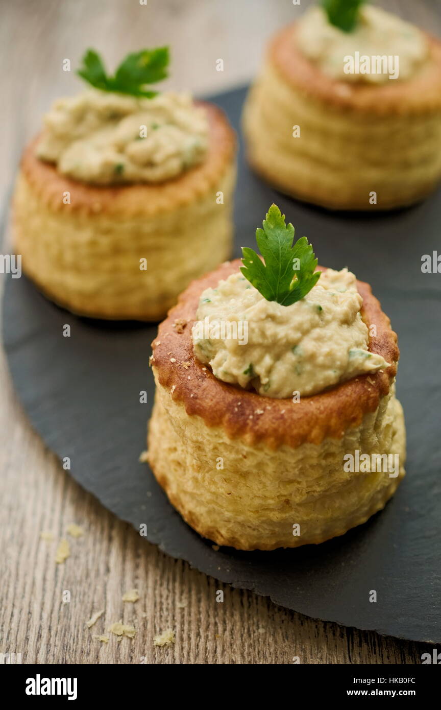 Puff pastry bouchees dough cups filled with tuna spread and garnished ...