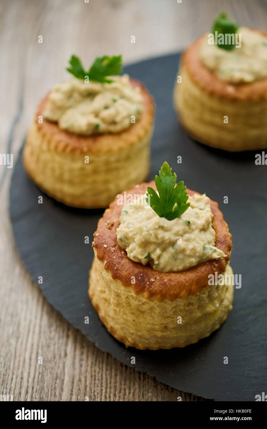 Puff pastry bouchees dough cups filled with tuna spread and garnished ...