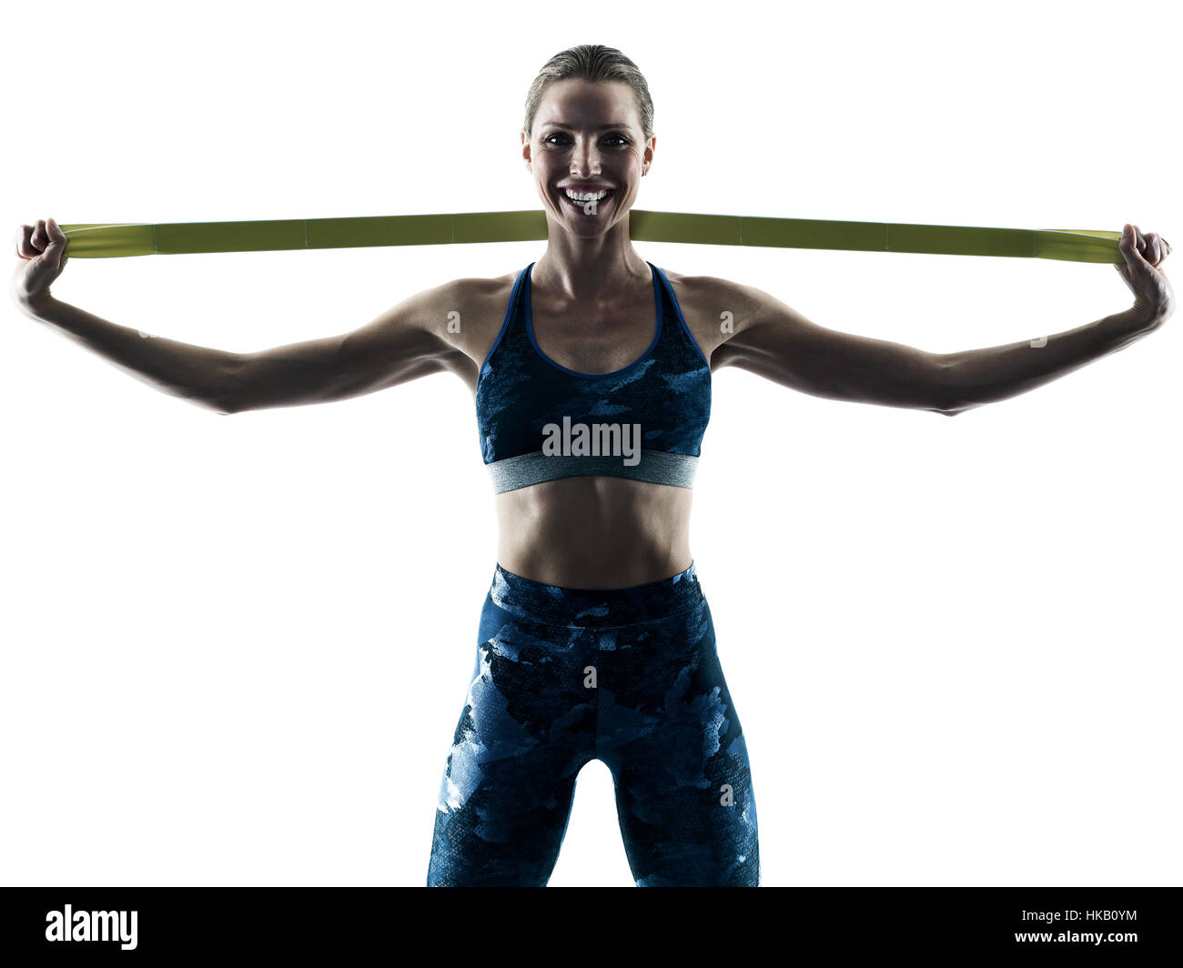 one caucasian woman exercising fitness elastic excercises in silhouette ...