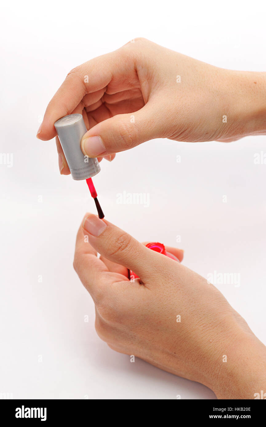 Painting nail finger with pink color Stock Photo - Alamy