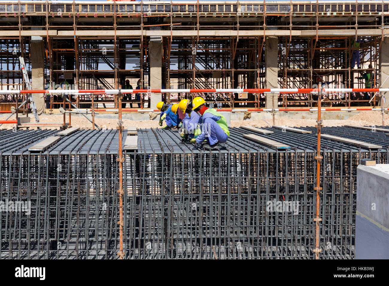 Construction workers knitting rebars for concrete foundation Stock ...