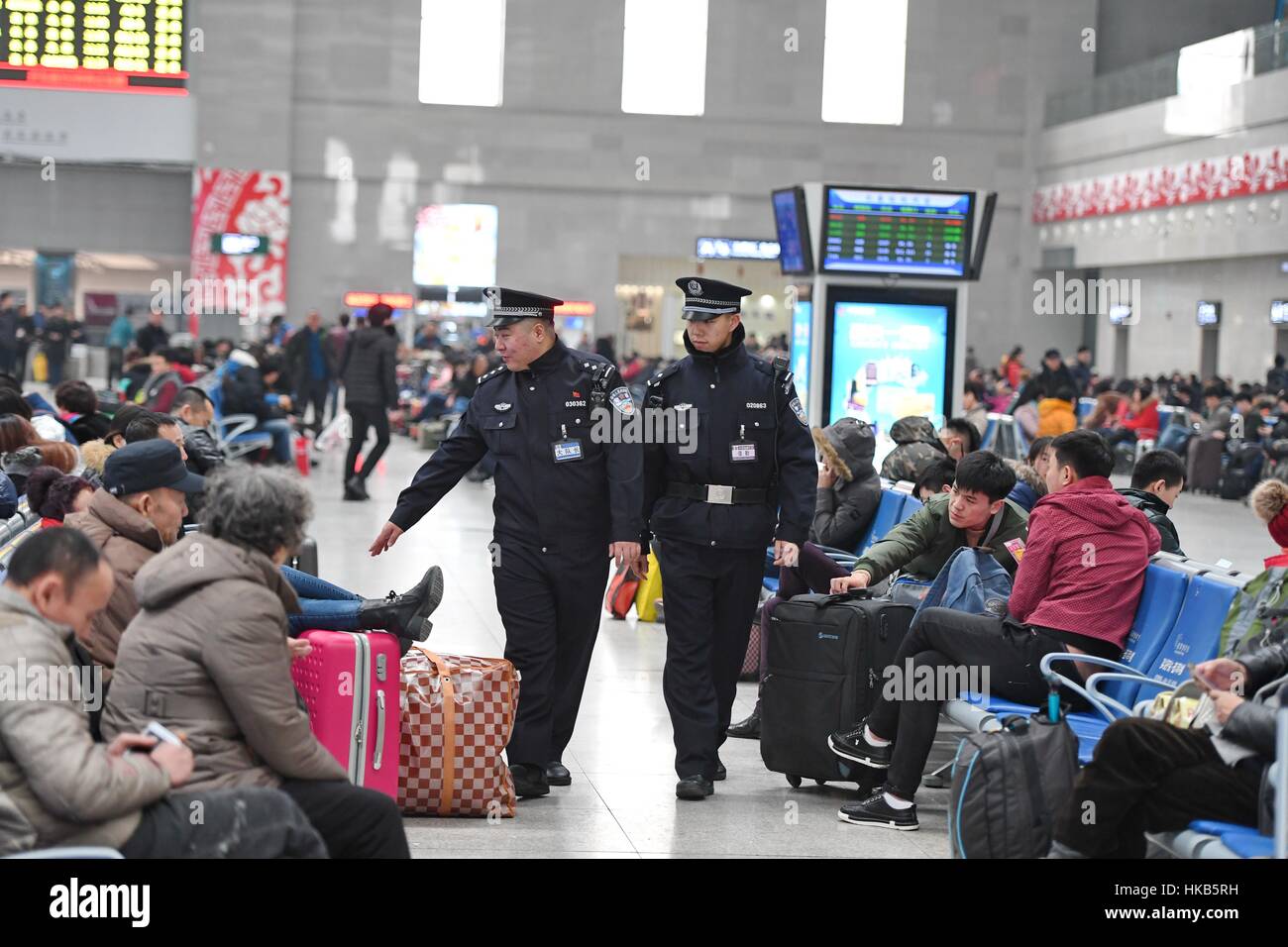 Changchun, China. 26th Jan, 2017. Police officers Gao Yang (C-L) and ...