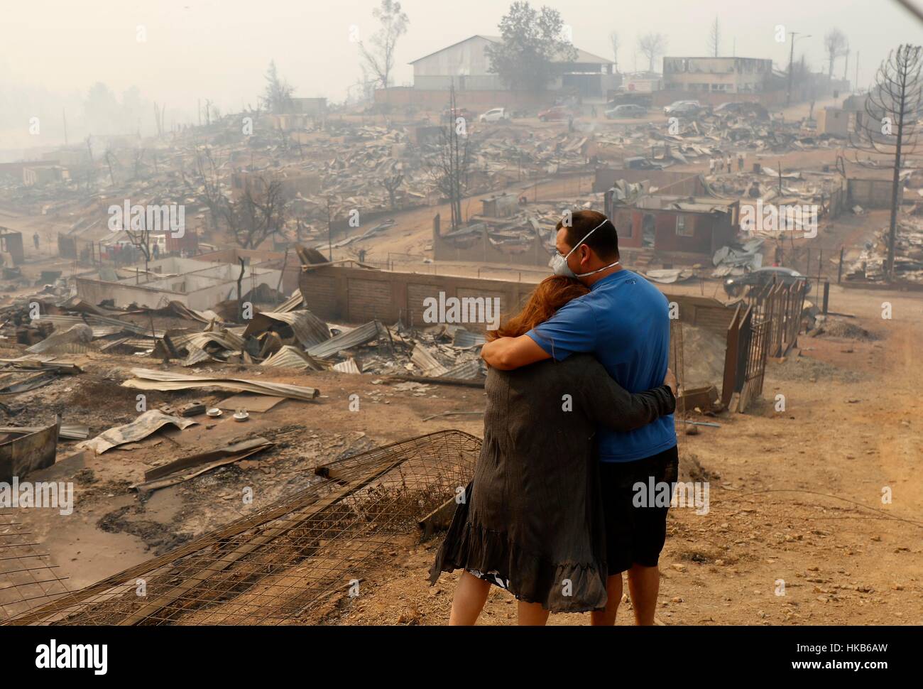 Santa Olga, Chile. 26th Jan, 2017. People watch houses affected after a ...