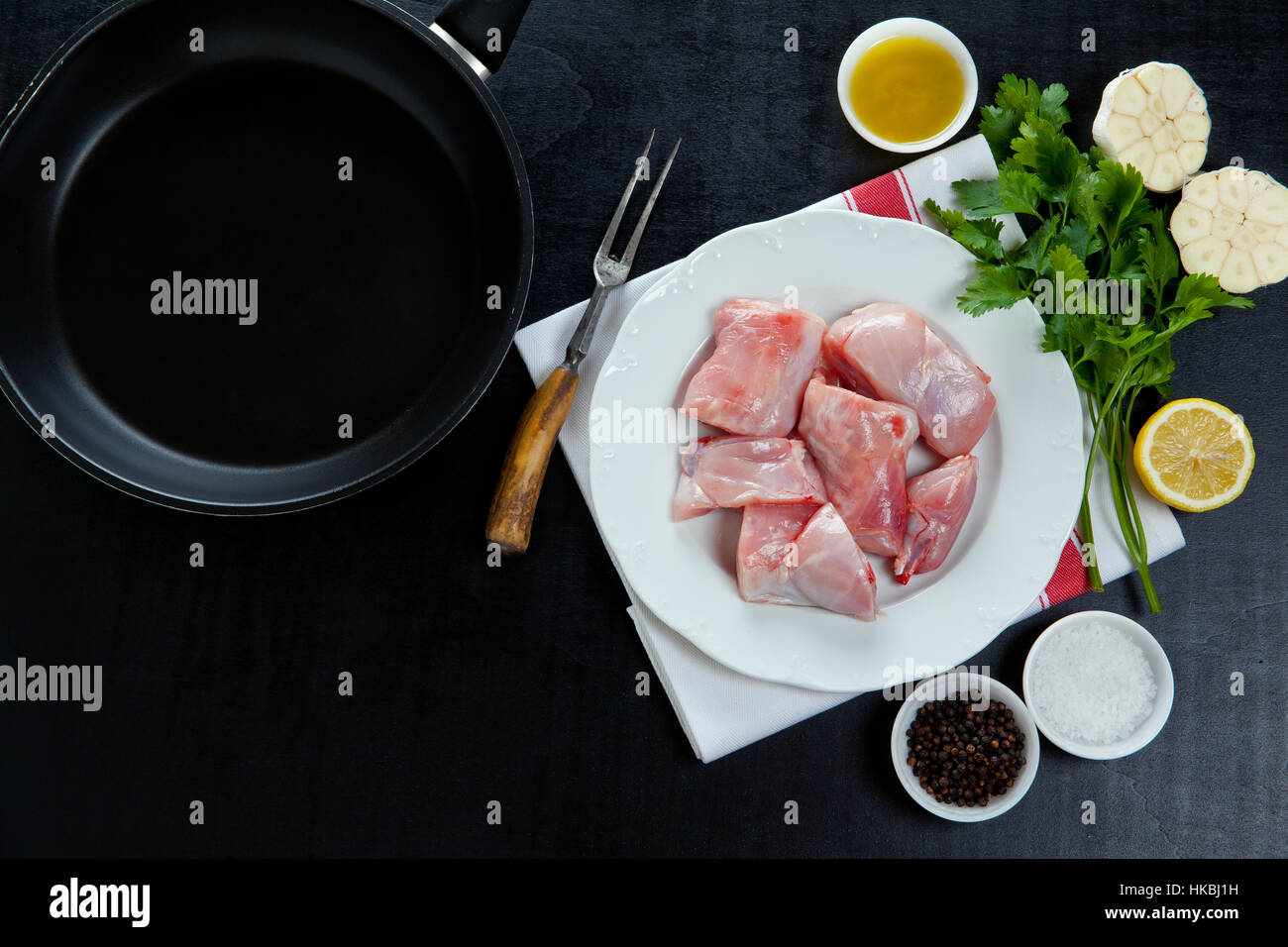raw rabbit meat with cooking ingredients and empty pan Stock Photo - Alamy