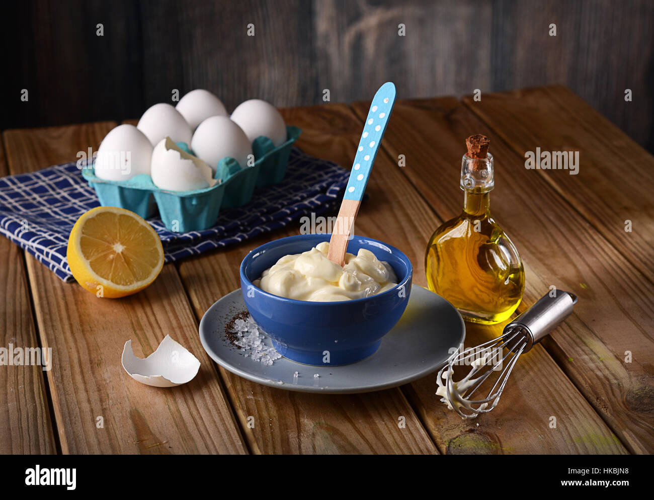 mayonnaise in blue bowl with ingredients around - traditional European ...