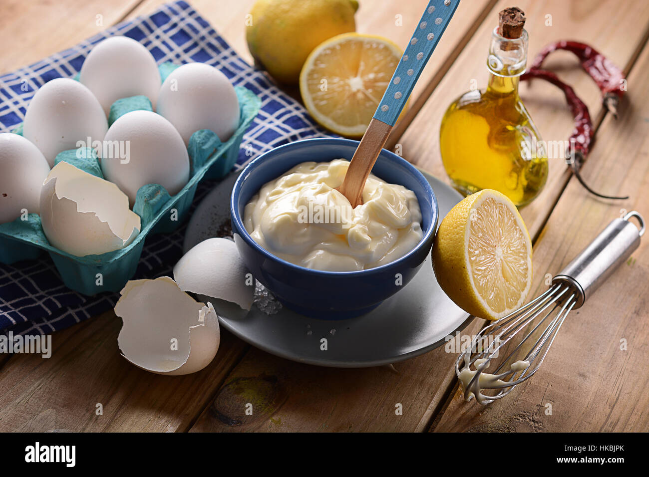mayonnaise in blue bowl with ingredients around - traditional European ...