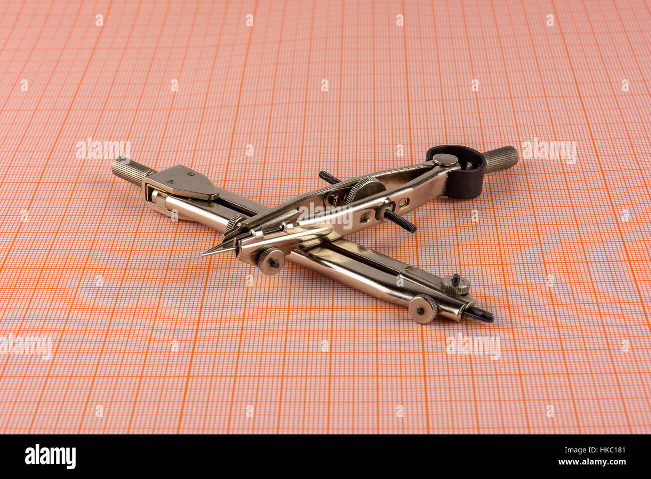 Two metal compass lying on a sheet of graph paper Stock Photo - Alamy