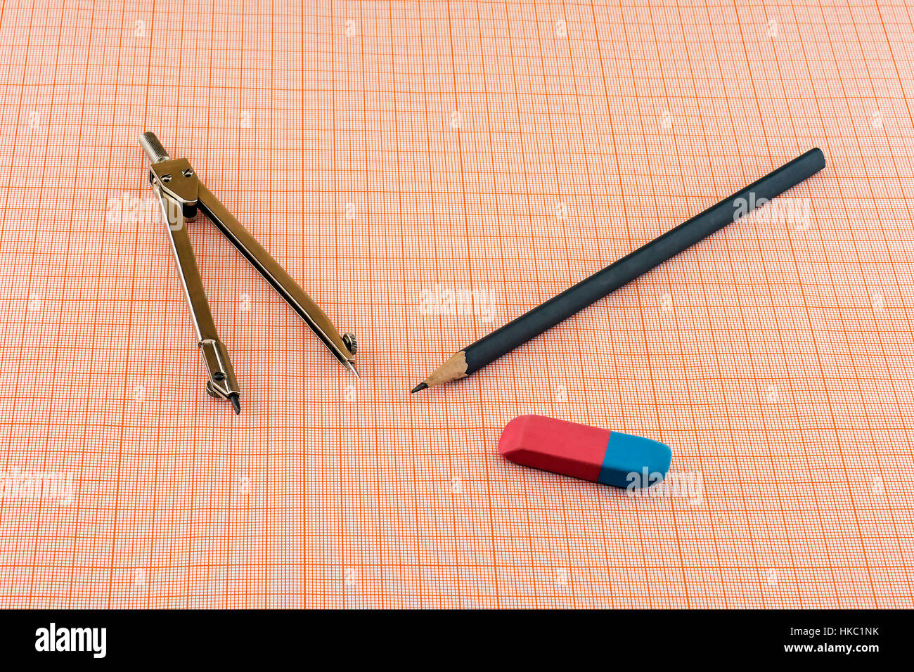 On a sheet of graph paper compass lie with pencil and eraser Stock ...