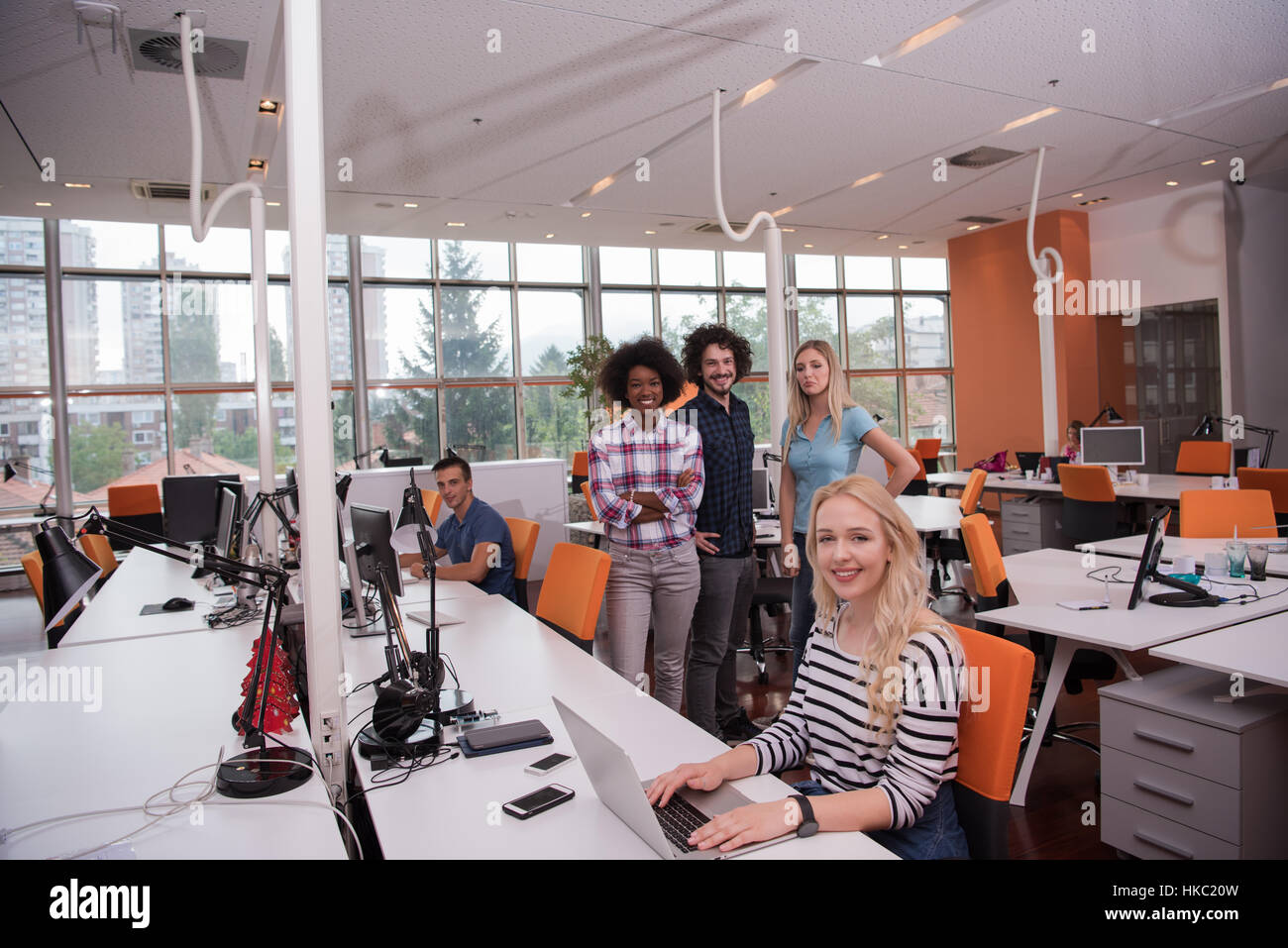 young smiling informal businesswoman working in the office with ...