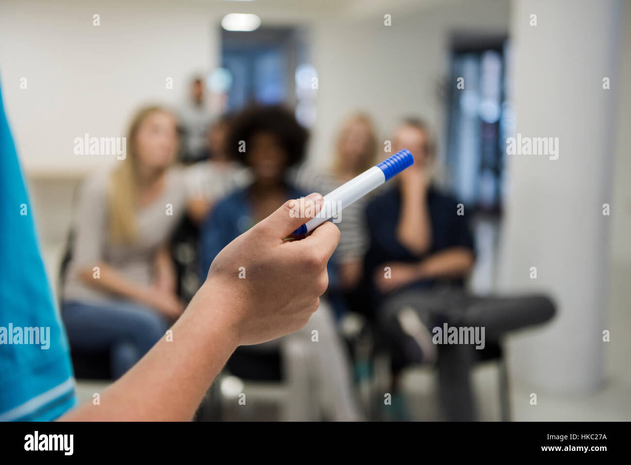 close up of teacher hand with marker while teaching lessons in school ...