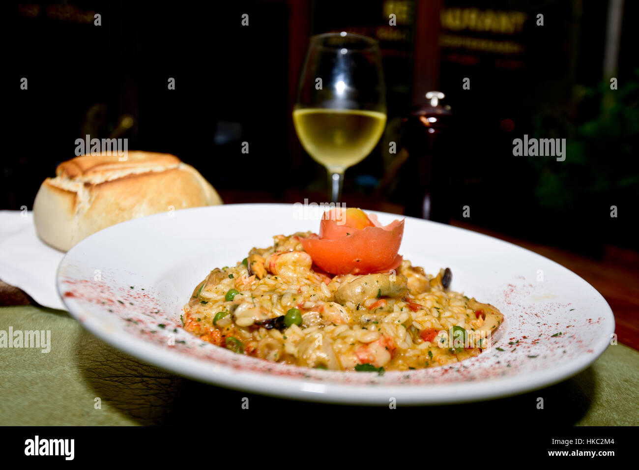 Risotto with a glass of white wine Stock Photo - Alamy