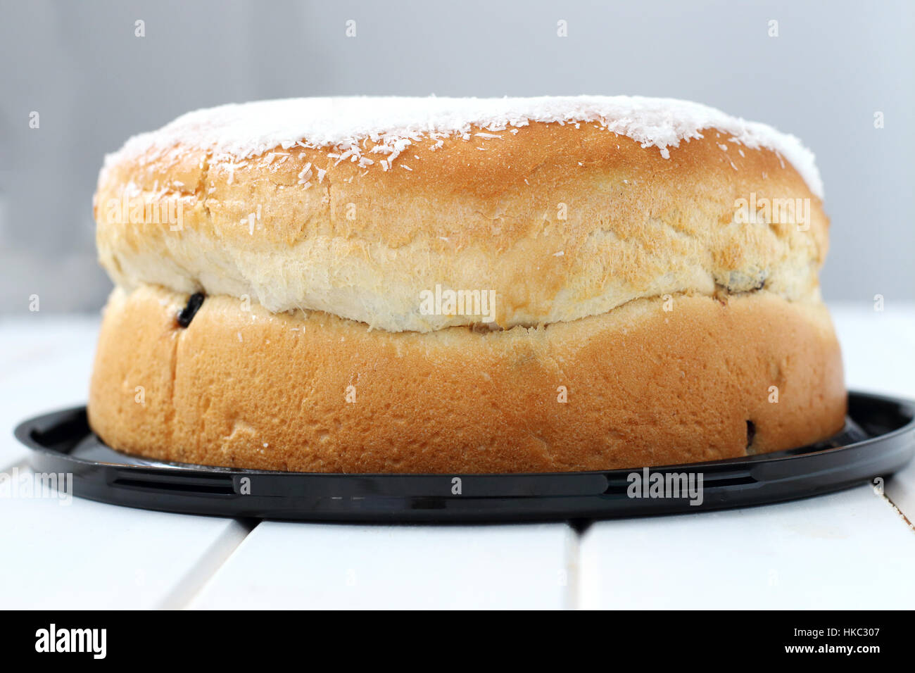 Boston Bun with coconut icing on white timber Stock Photo - Alamy