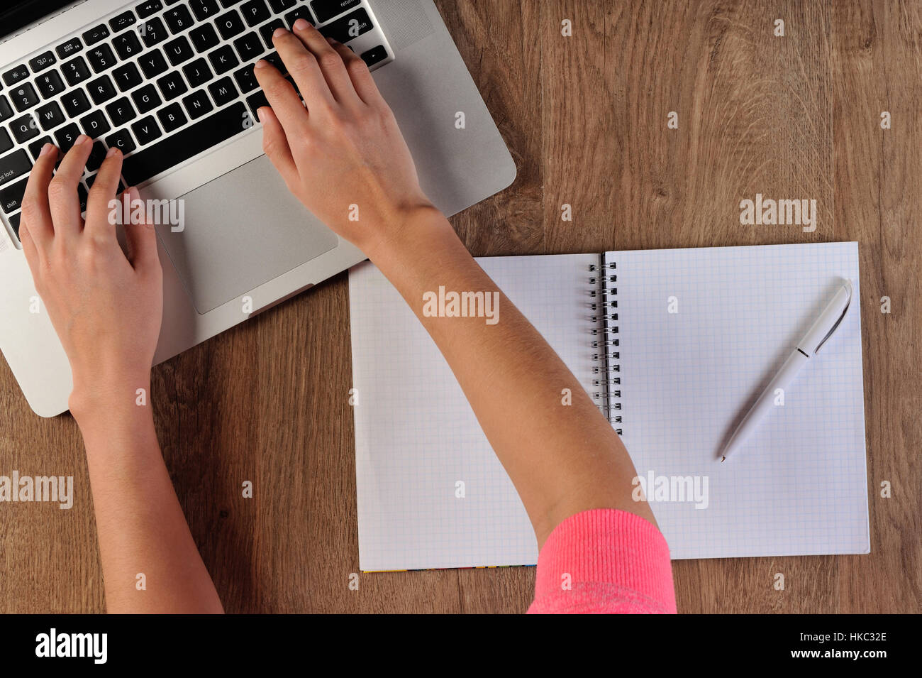person writing in notebook infront of laptop Stock Photo - Alamy