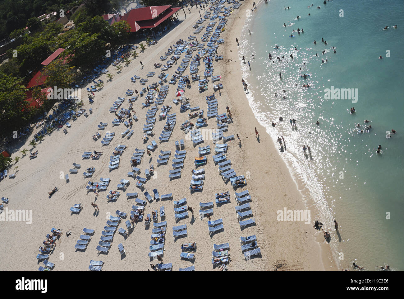 People relaxing on beach chairs in caribbean Stock Photo - Alamy