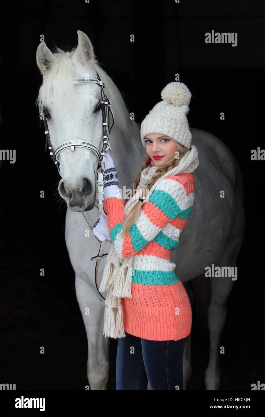 Beautiful young equestrian girl in winter evening fields Stock Photo ...