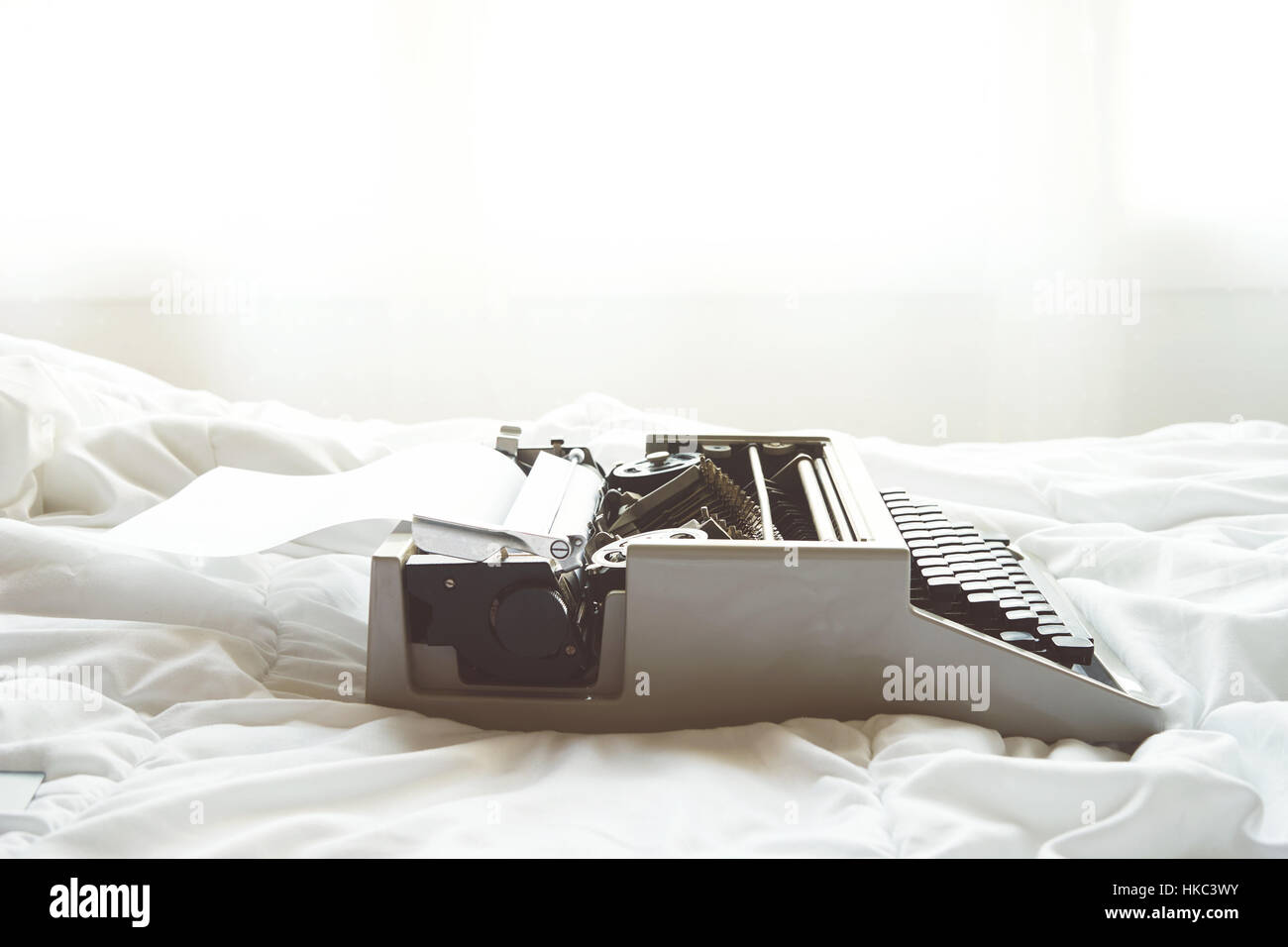 Vintage typewriter on the bed Stock Photo - Alamy
