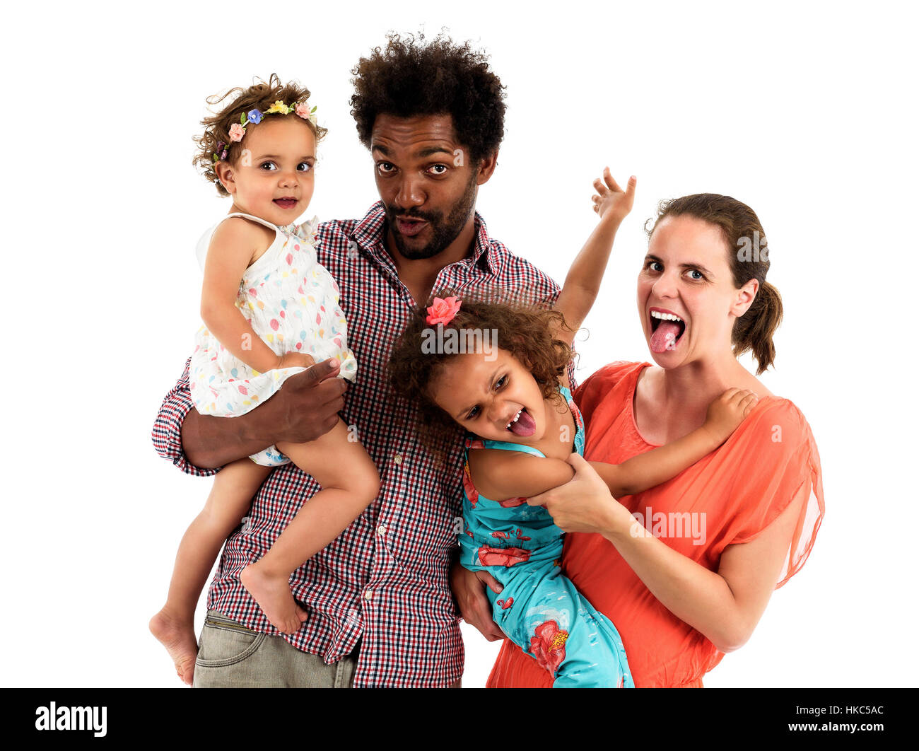 Happy interracial family is celebrating, laughing and having fun with ...