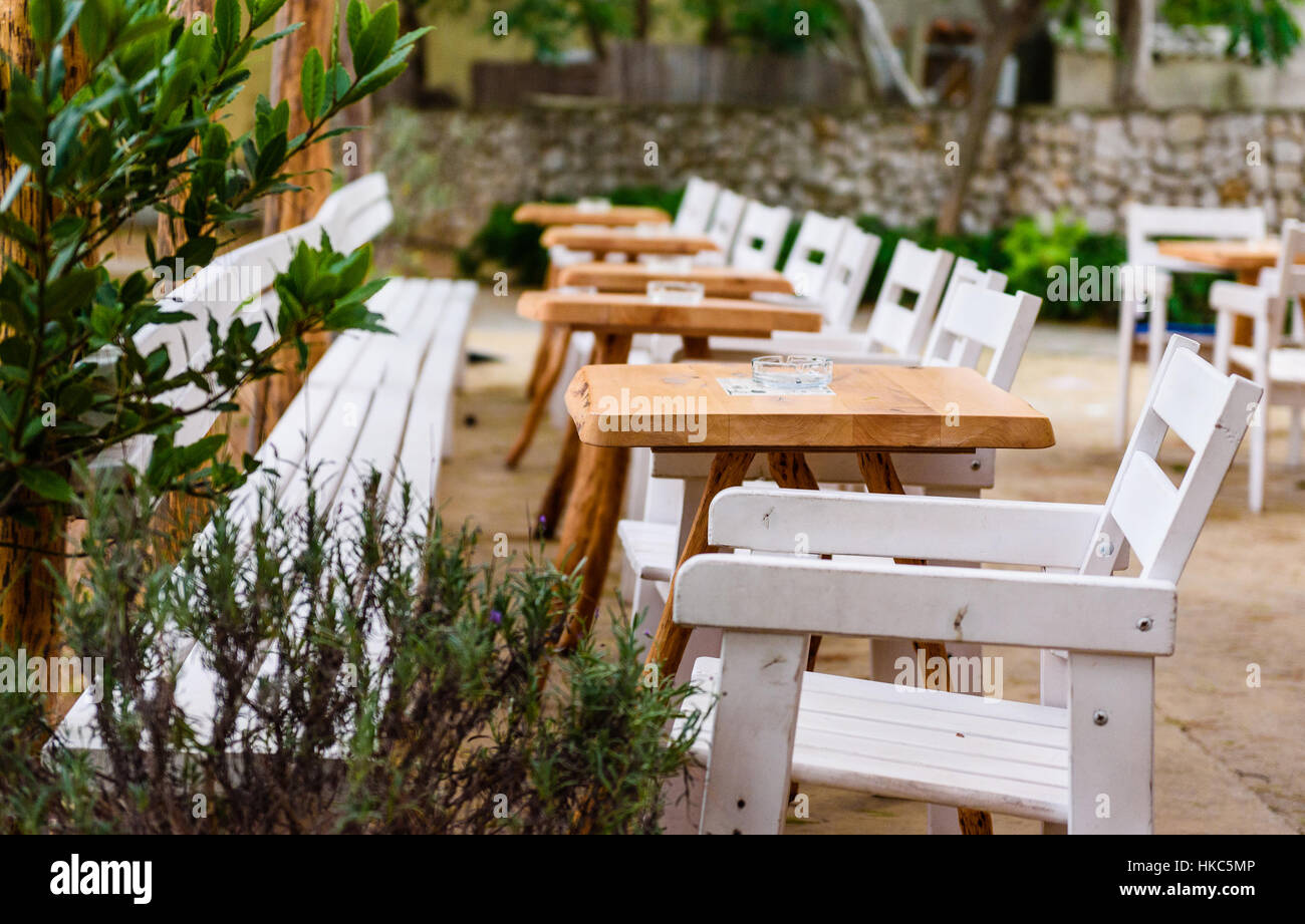 Caffe bar or restaurant with white chairs and tables. Nice place to eat ...