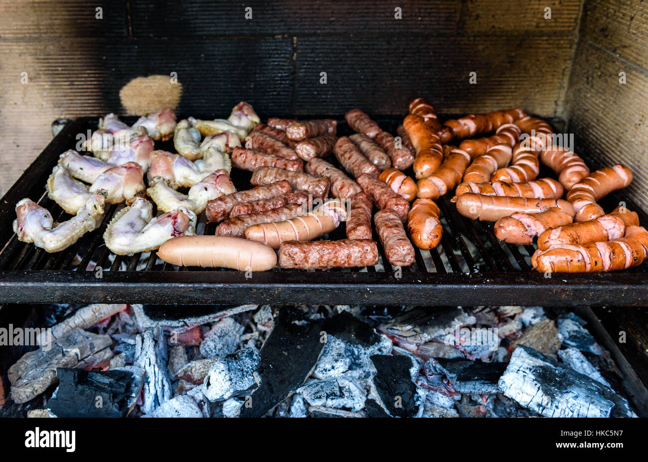Mixed variety of Meat on barbecue grill with coal. Cevapcici, sausages ...