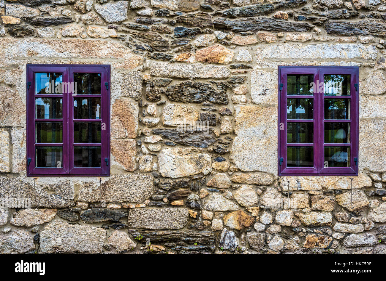 Purple window on medieval castle made of stone and rocks. Architectural ...
