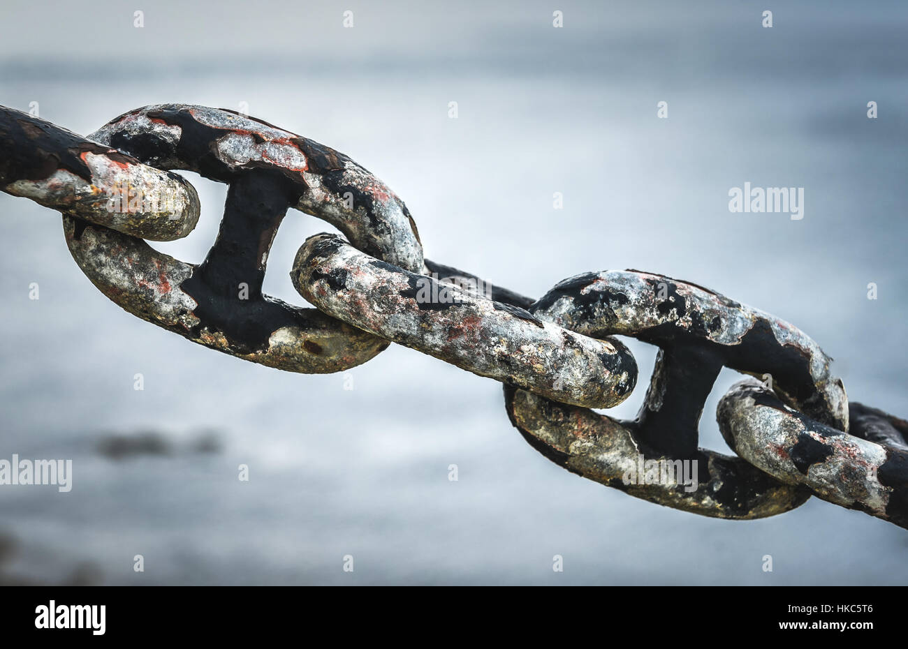 Old rusty anchor iron ship chain in sea port. Old fence made of ...