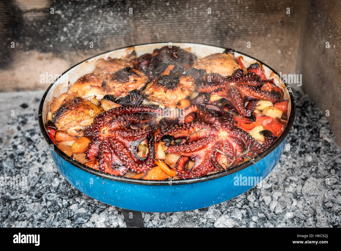 Preparing and Cooking of octopus and chicken in traditional Balkan ...