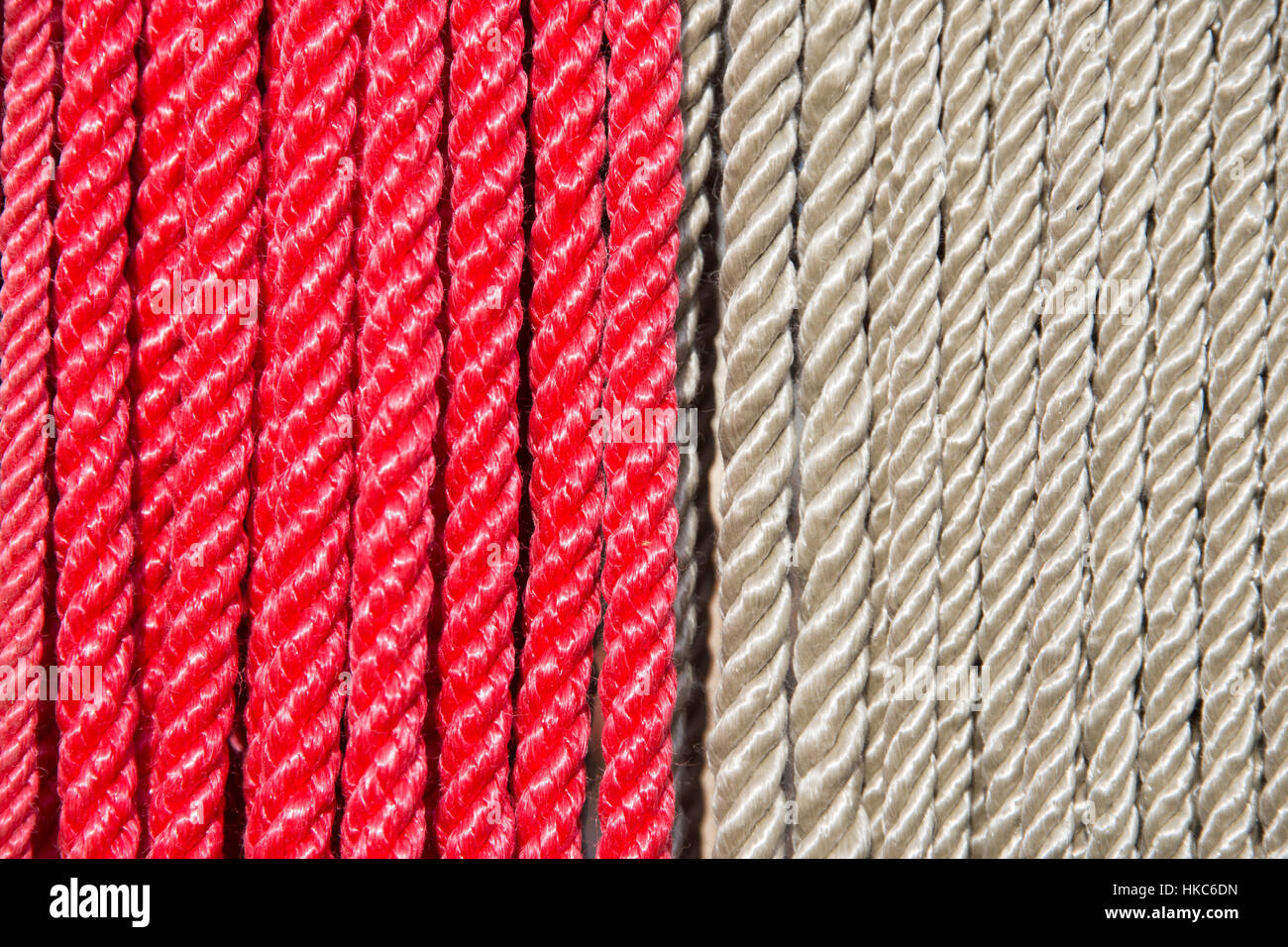 Red and white colored rope hanging on market for sale Stock Photo - Alamy