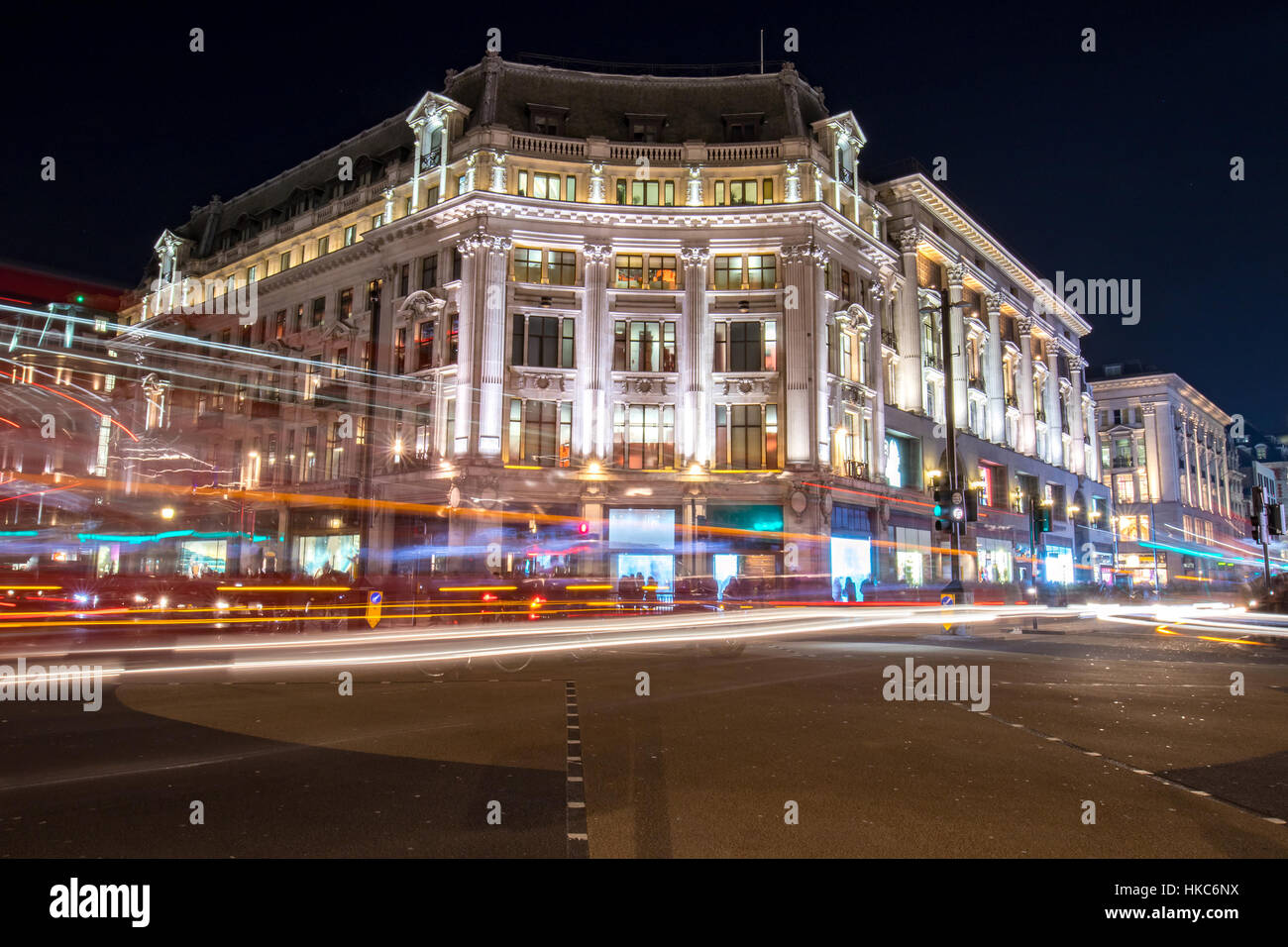Night view on a corner building in one of the busiest streets in london ...