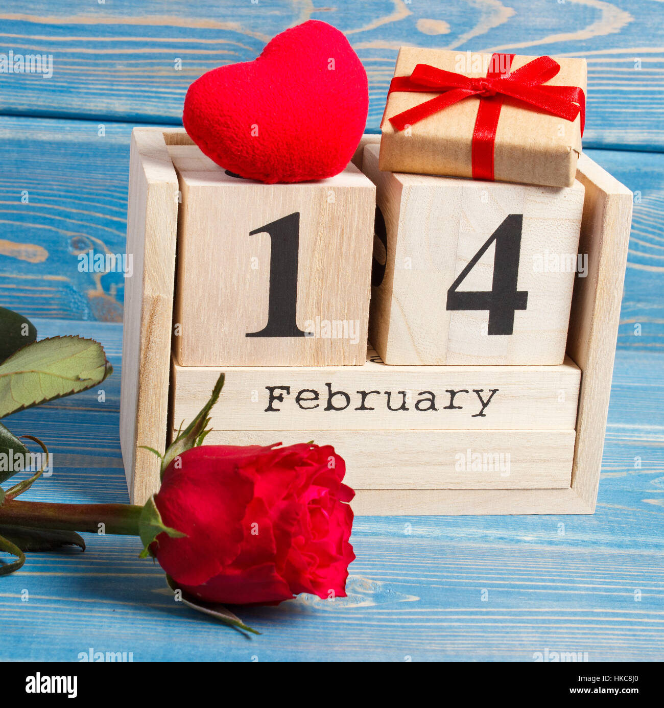 February 14 on cube calendar, wrapped gift with ribbon, red heart and ...