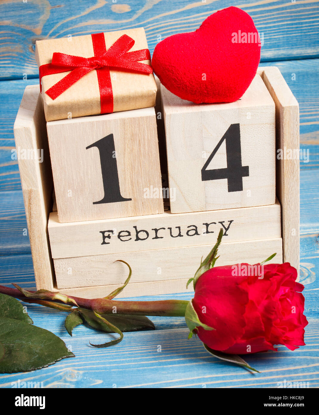 February 14 on cube calendar, wrapped gift with ribbon, red heart and ...
