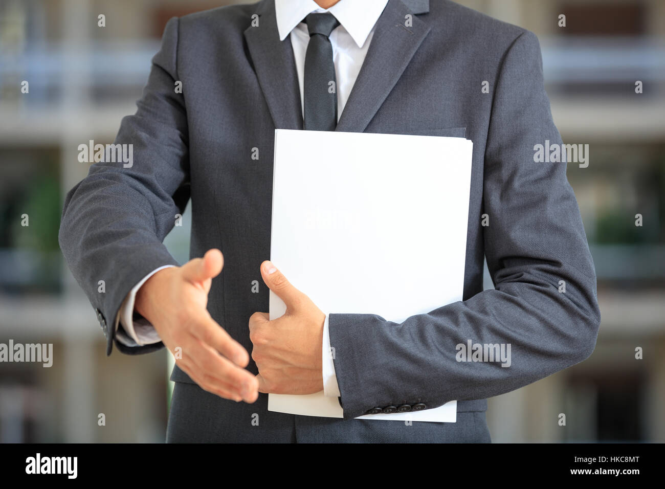 Manager in suit offering a handshake Stock Photo - Alamy