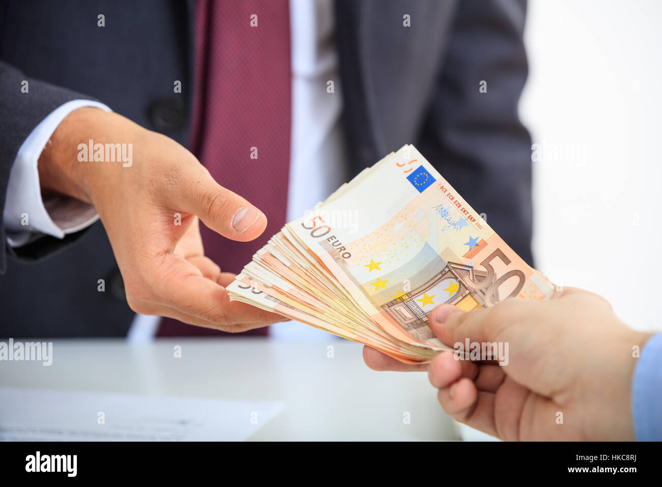 Man in suit receiving money Stock Photo - Alamy