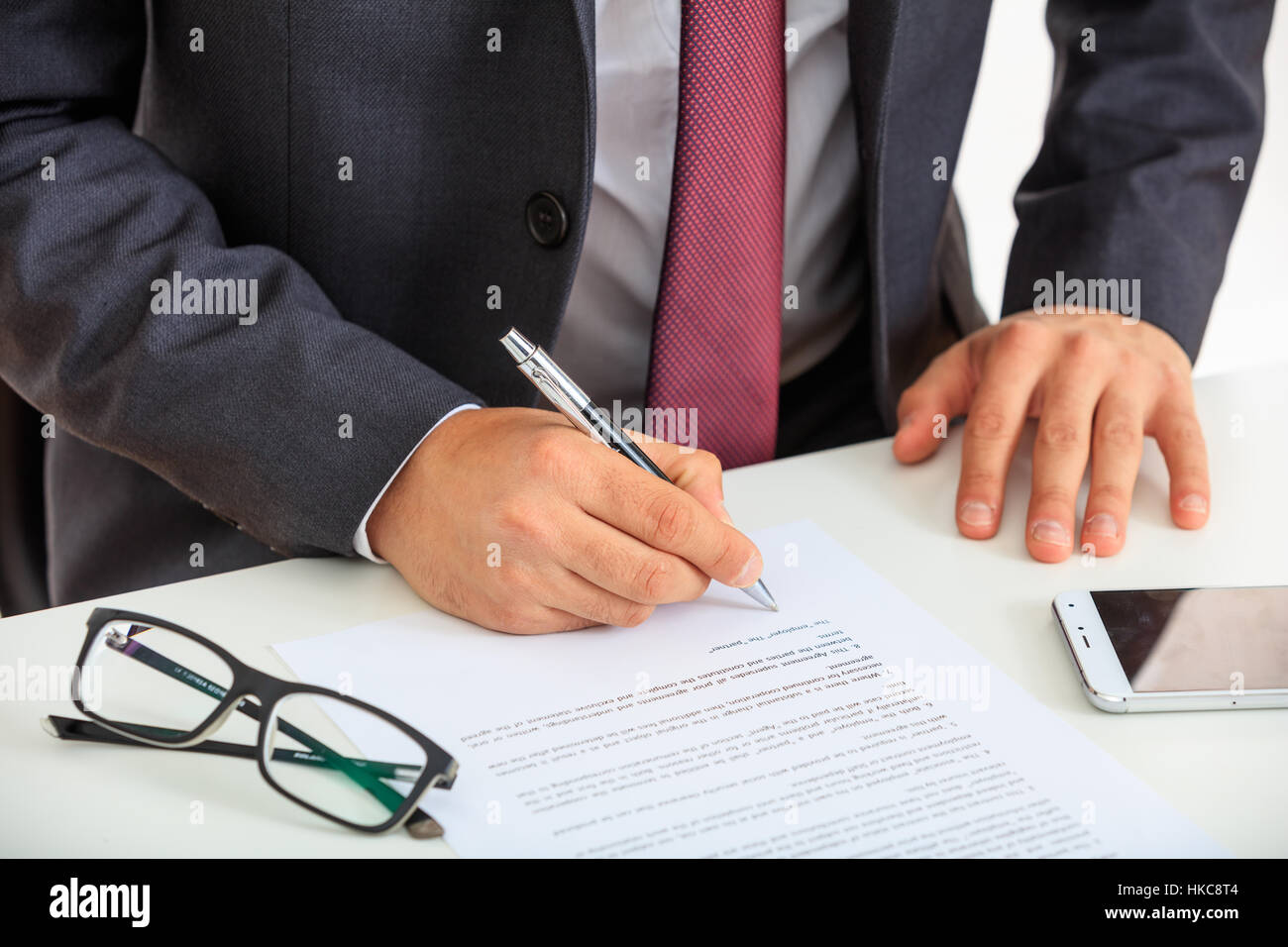 Businessman signing an agreement Stock Photo - Alamy