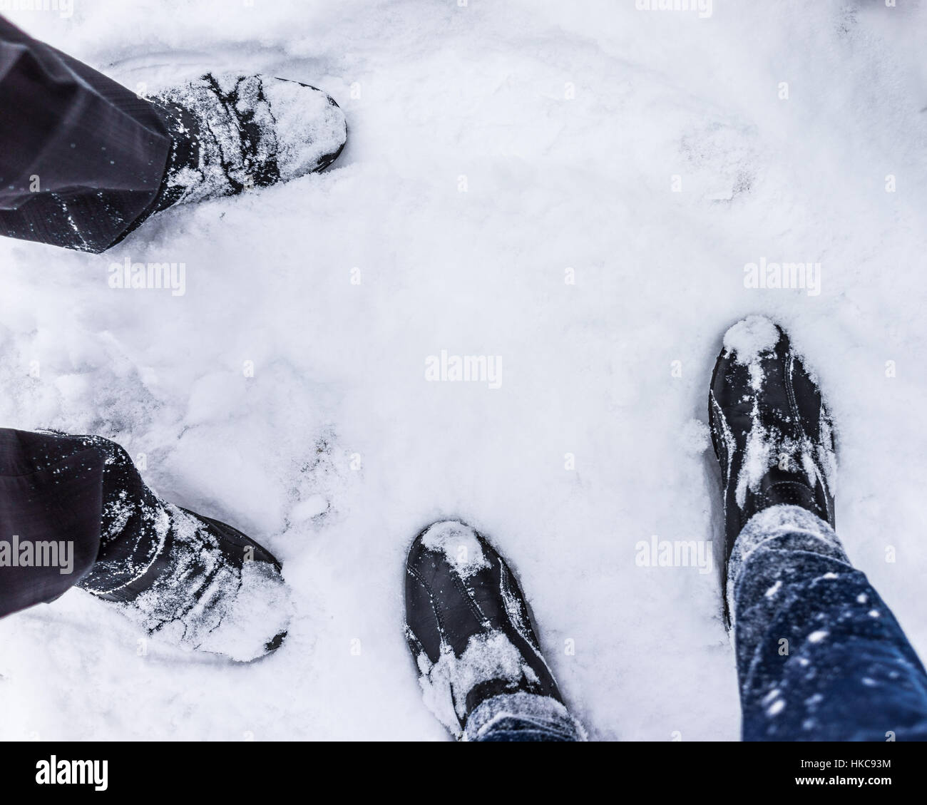 Two people's feet leather shoes in winter snow Stock Photo - Alamy