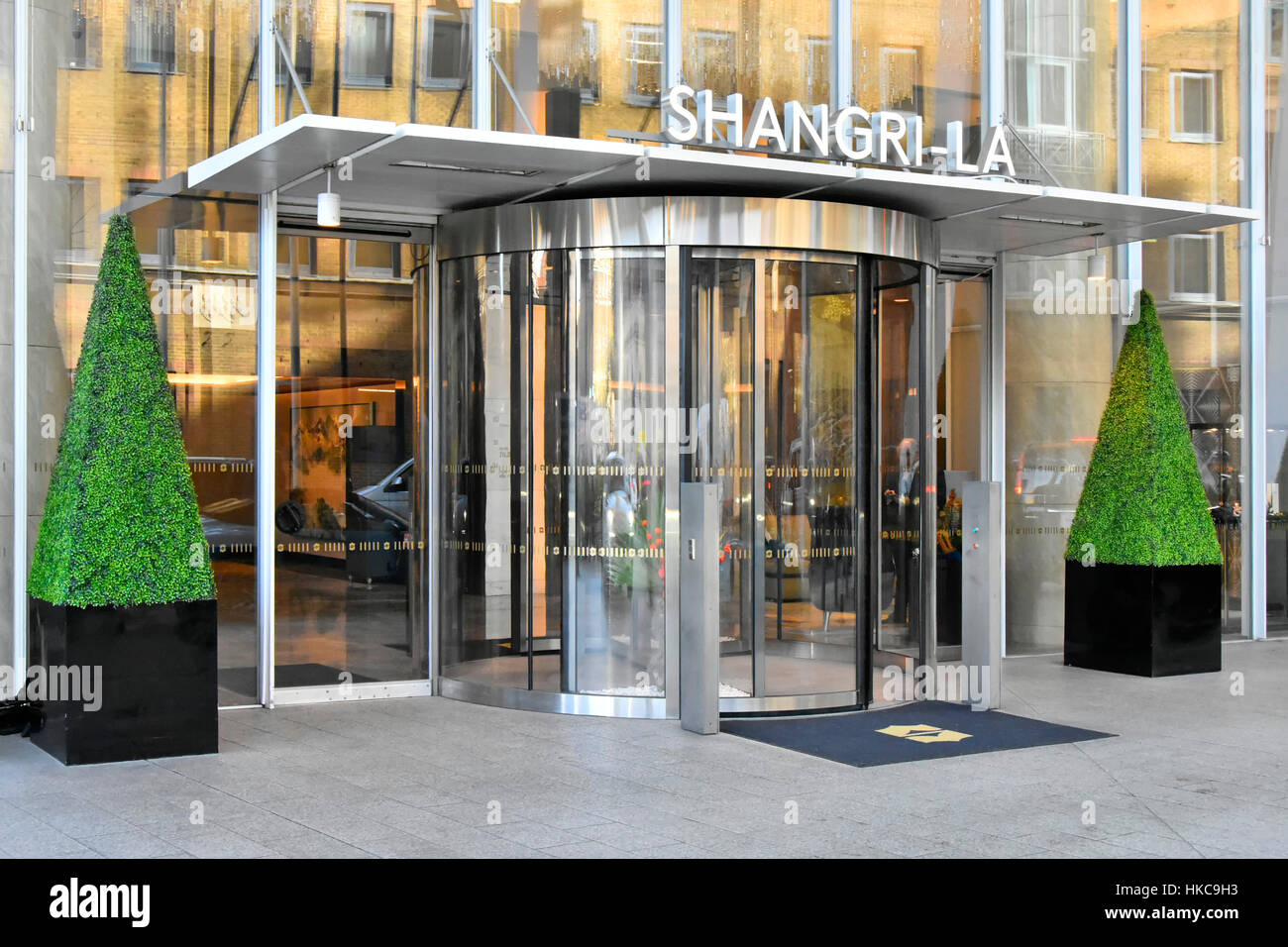 Revolving door entrance with sign above to the Shangri La luxury hotel ...