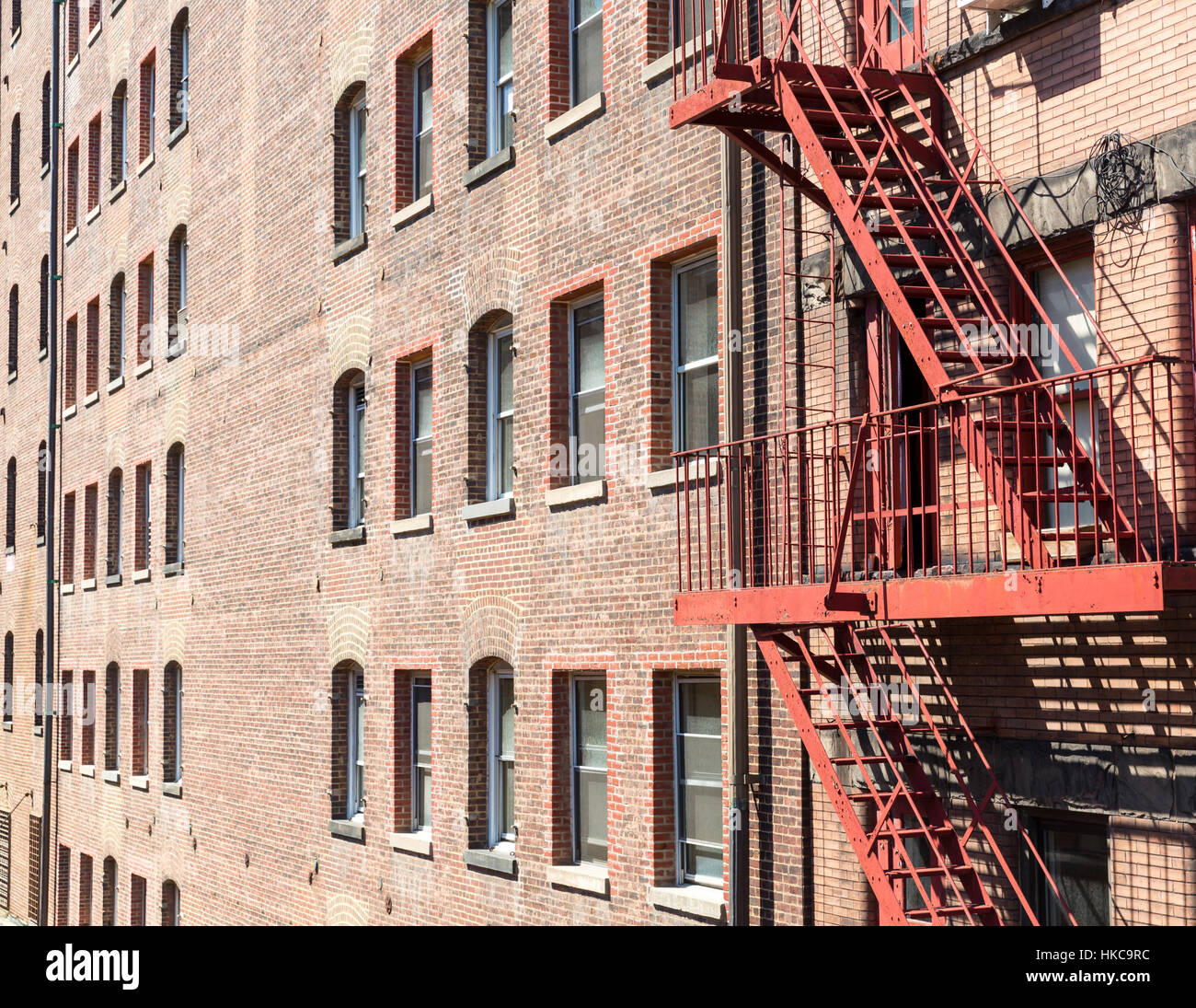 Closeup of brick building with fire ladders Stock Photo - Alamy