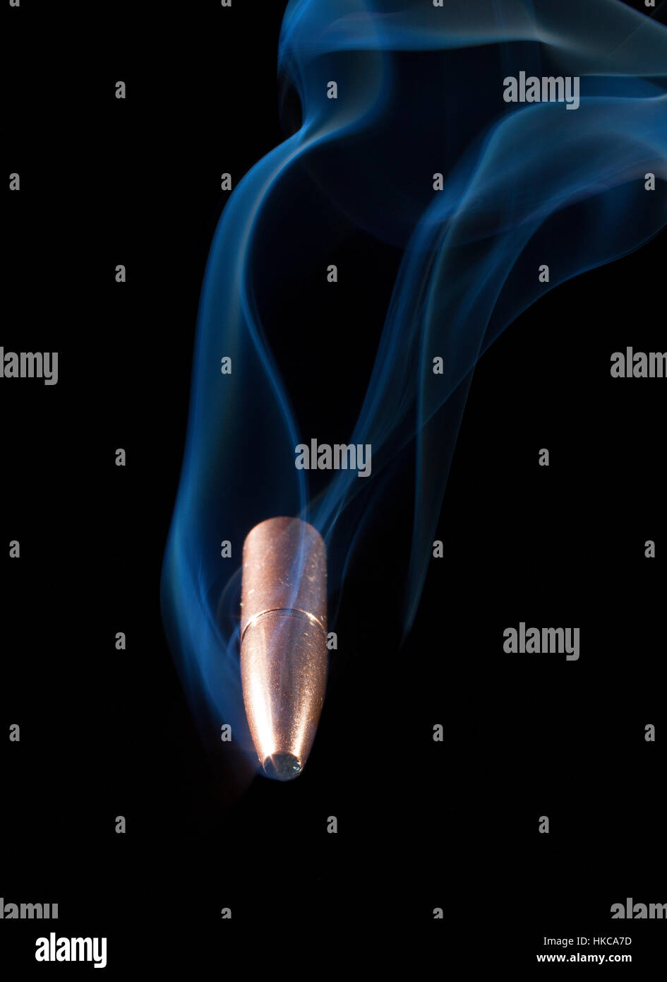 Copper plated bullet with smoke behind coming at the camera Stock Photo ...