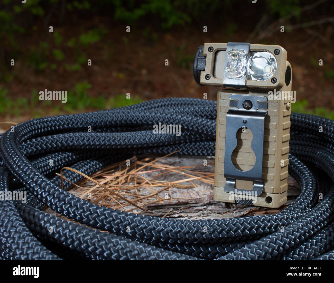 Brown flashlight that is shaped square surrounded by a black rope Stock ...