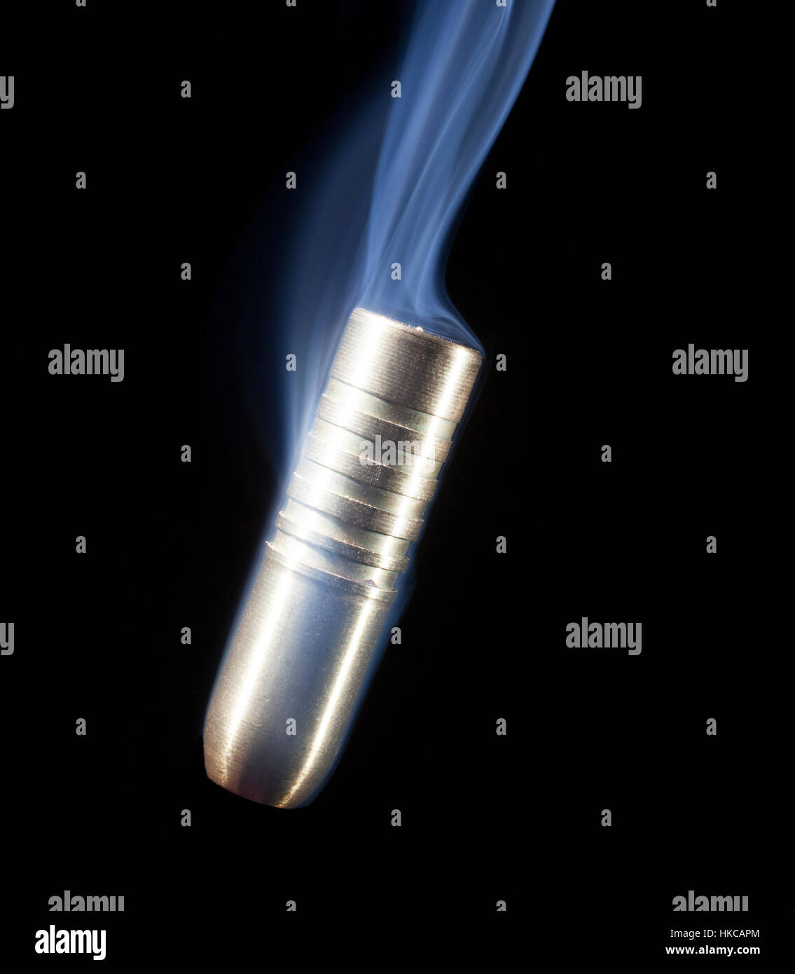 Copper bullet with smoke heading down on a black background Stock Photo ...