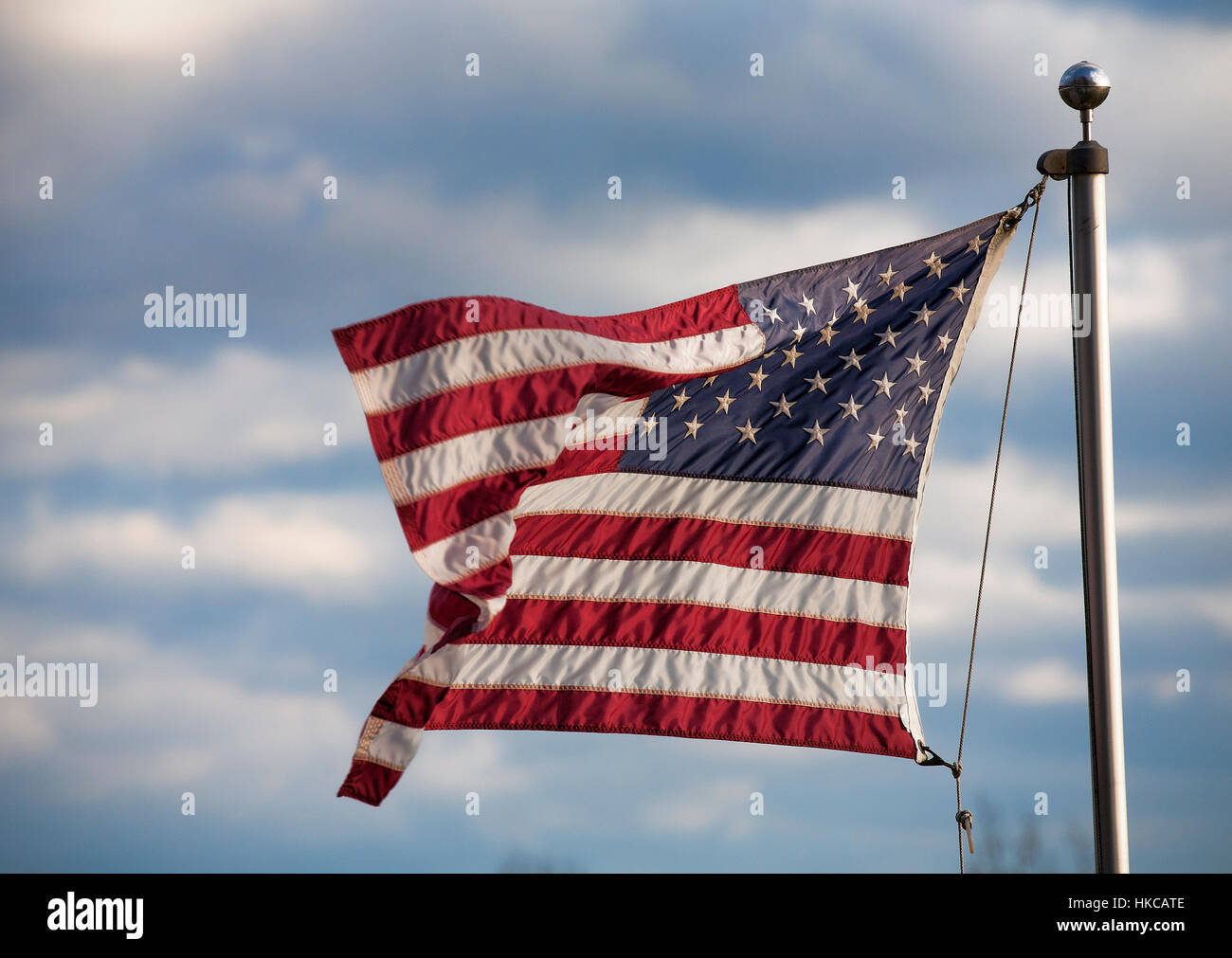 American flag waving in a breeze with clouds behind Stock Photo - Alamy