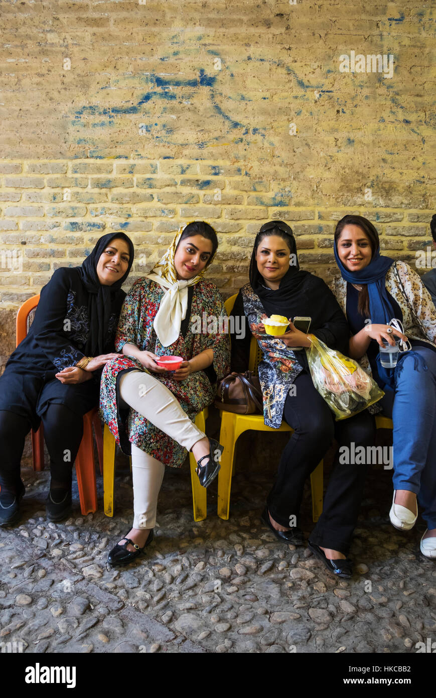 Young women enjoying fallodeh frozen dessert at the Vakil Bazaar ...