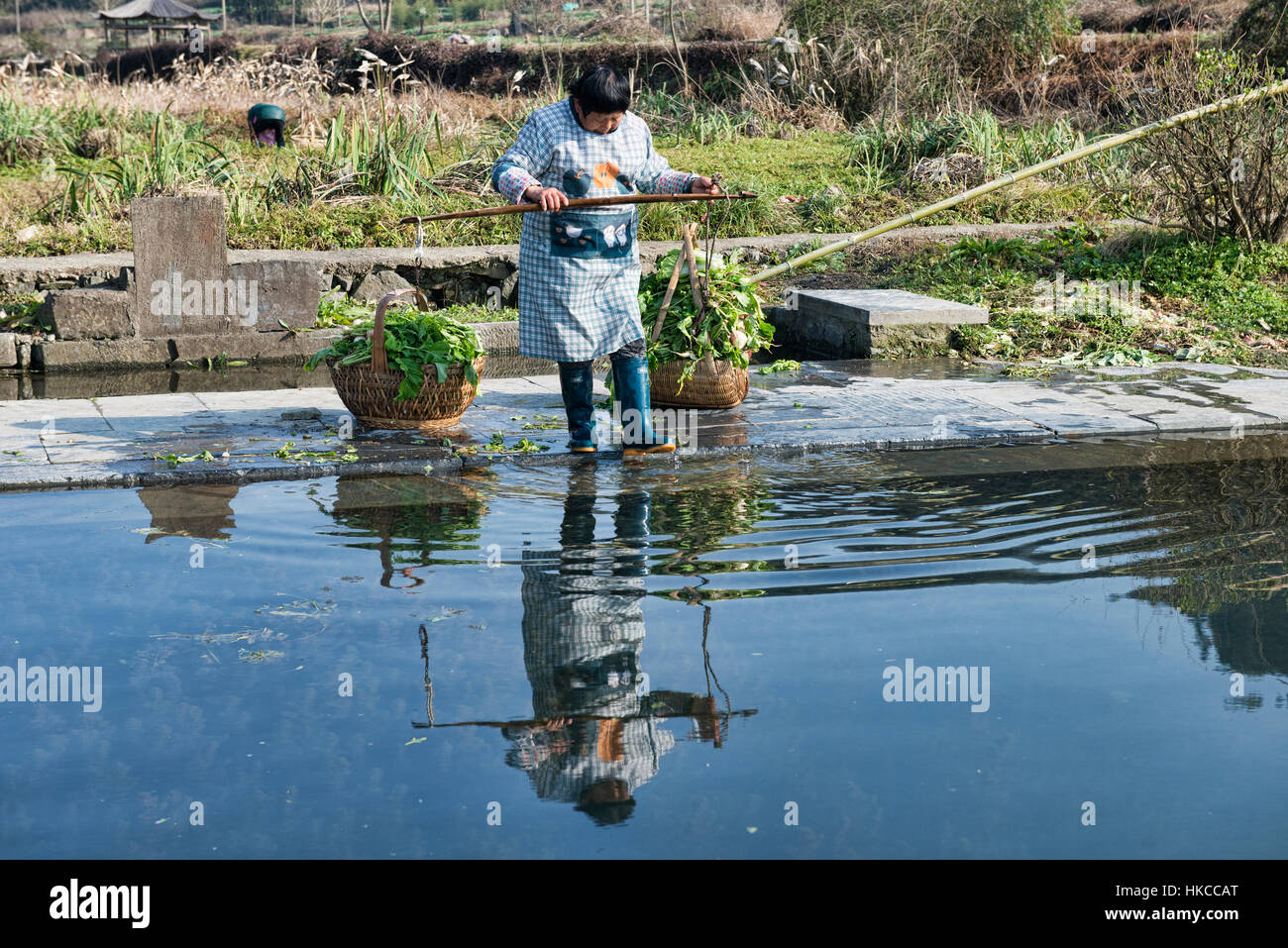 A farmer and her vegetables in the ancient village of Xidi, Anhui ...