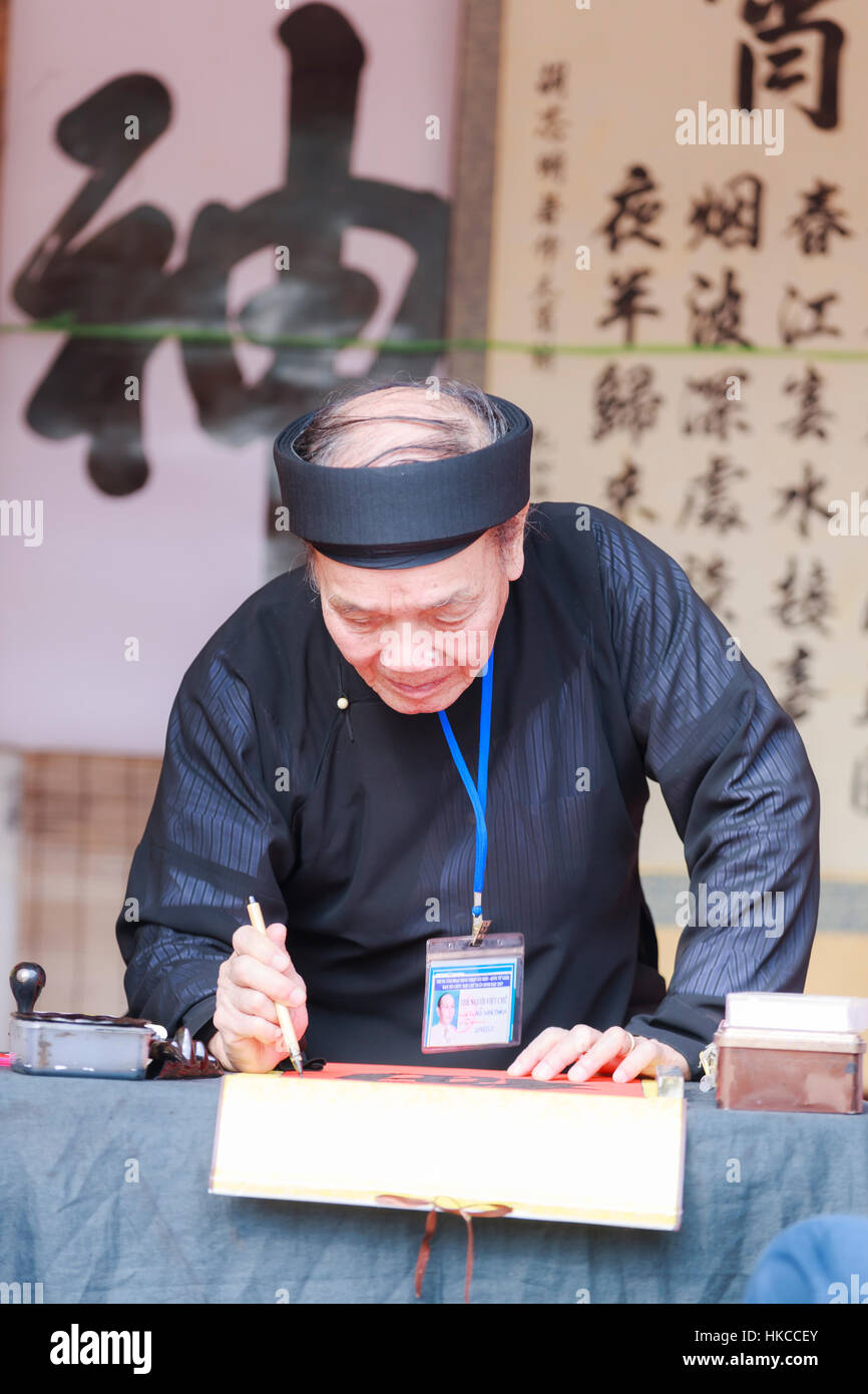 A scholar writes Chinese calligraphy characters at Temple of Literature ...