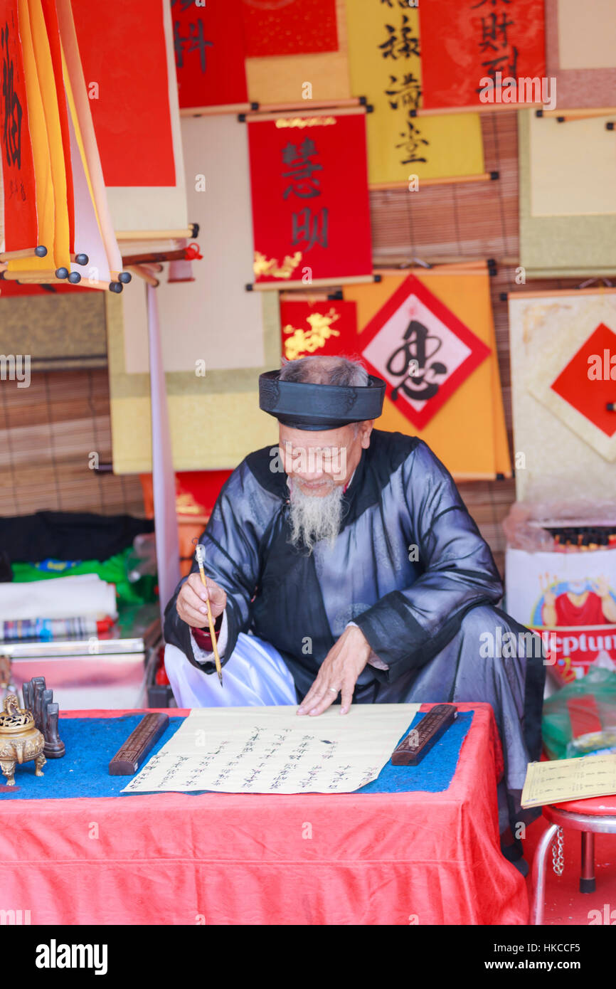 A scholar writes Chinese calligraphy characters at Temple of Literature ...