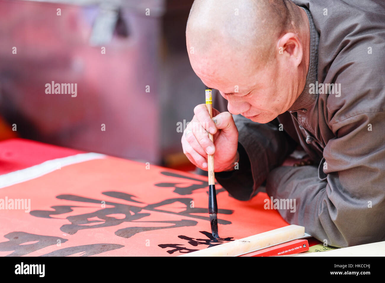 A scholar writes Chinese calligraphy characters at Temple of Literature ...